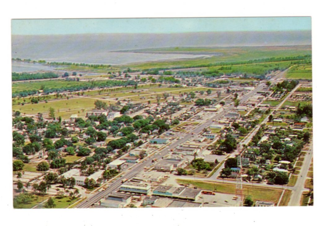 Chrome postcard. City of Clewiston looking east showing Clewiston Inn ...